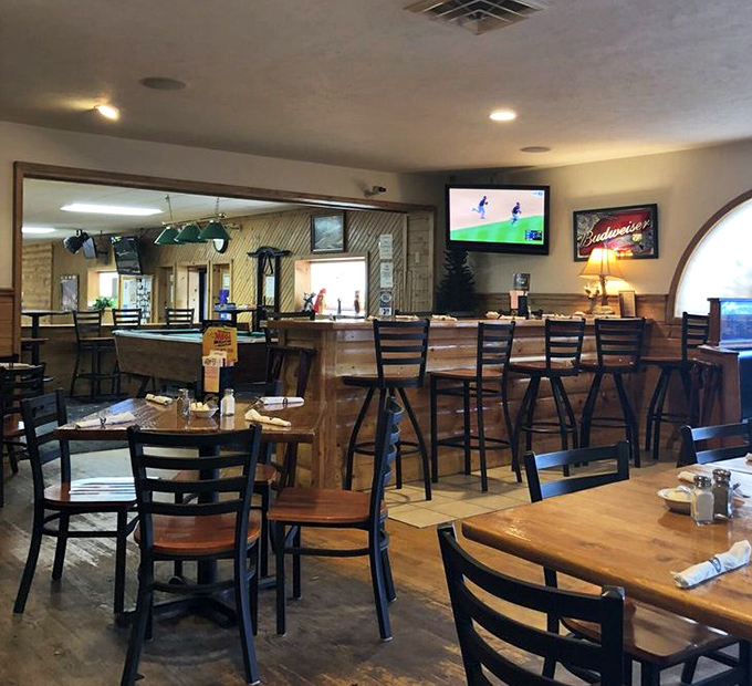 The dining area balances rustic charm with comfortable seating, creating the perfect backdrop for the serious business of enjoying a great meal.