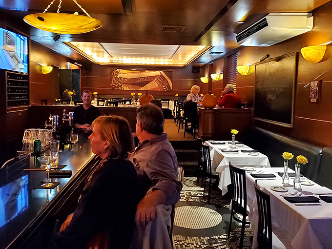 The bar area balances old-school charm with modern comfort&mdash;like if Frank Sinatra designed a living room for friends.