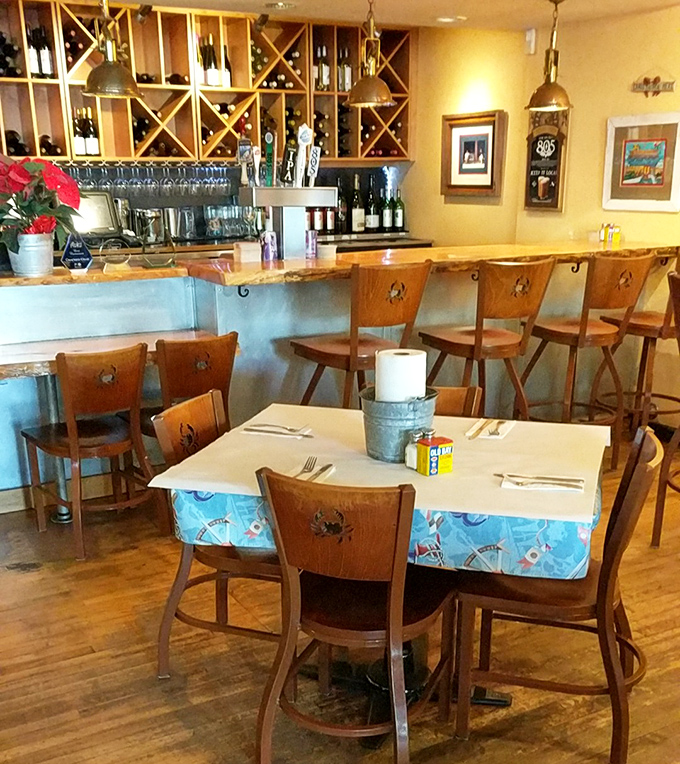 The bar area combines coastal charm with California wine country sensibility. That "FISH STORIES TOLD HERE" sign isn't kidding around.