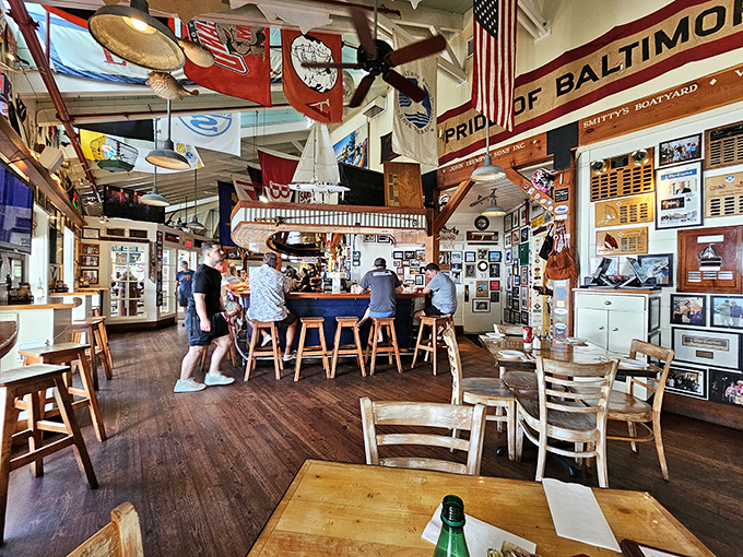 The bar area buzzes with maritime energy, where flags hang from the ceiling and every inch tells a story of Chesapeake Bay adventures.