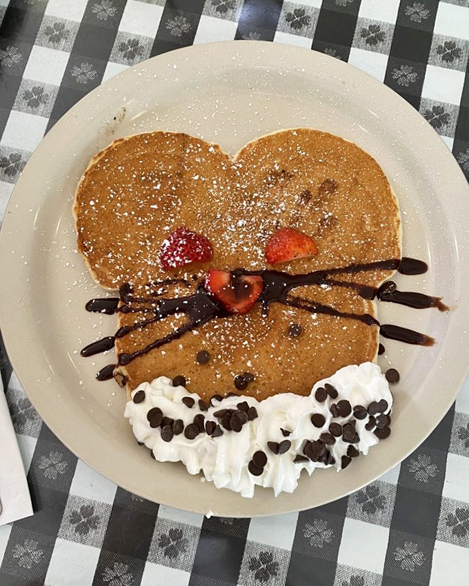 Pancakes with personality! This whimsical creation turns breakfast into an event. The chocolate chip smile says "good morning" better than any barista ever could.