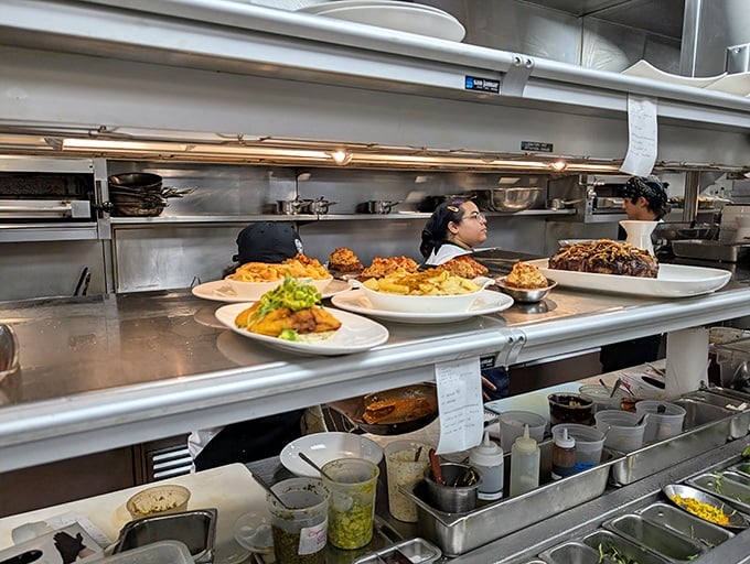 Behind the scenes, the kitchen ballet unfolds&mdash;plates lined up with military precision waiting for their grand entrance to your table.