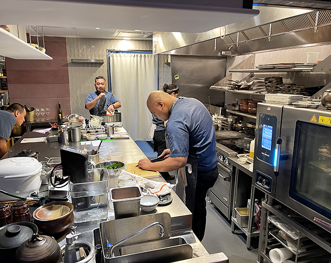 "Where the magic happens – Kaya's kitchen is a symphony of stainless steel, skilled hands, and recipes that have crossed oceans to reach your plate."