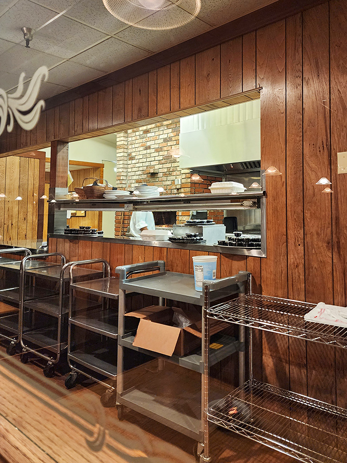 A glimpse into the kitchen – the engine room where oak-fired magic happens behind wood-paneled walls.