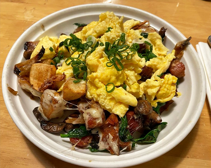 The aptly named "Kitchen Sink" dish&mdash;scrambled eggs nestled among potatoes, bacon, and greens. Breakfast architecture that somehow manages to be both rustic and refined.