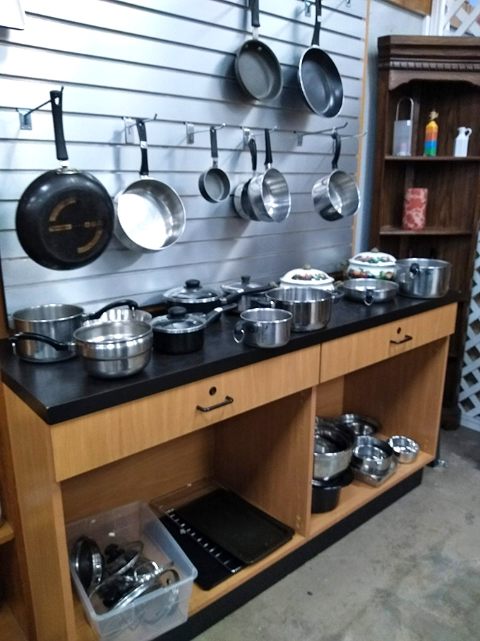 The cookware section &ndash; where professional-grade pots hang out with quirky vintage pans, waiting for their next culinary adventure.