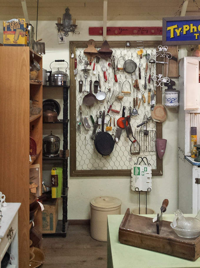 Kitchen implements hanging like notes on a culinary staff, each utensil a testament to meals prepared and families gathered.