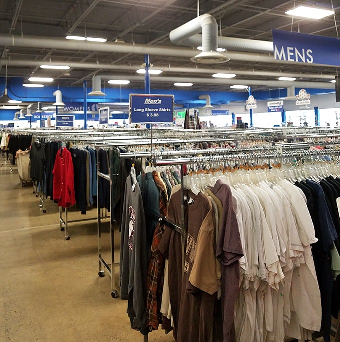 The men's section: where dress shirts that once attended important meetings now hang hopefully, dreaming of second interviews and wedding receptions.