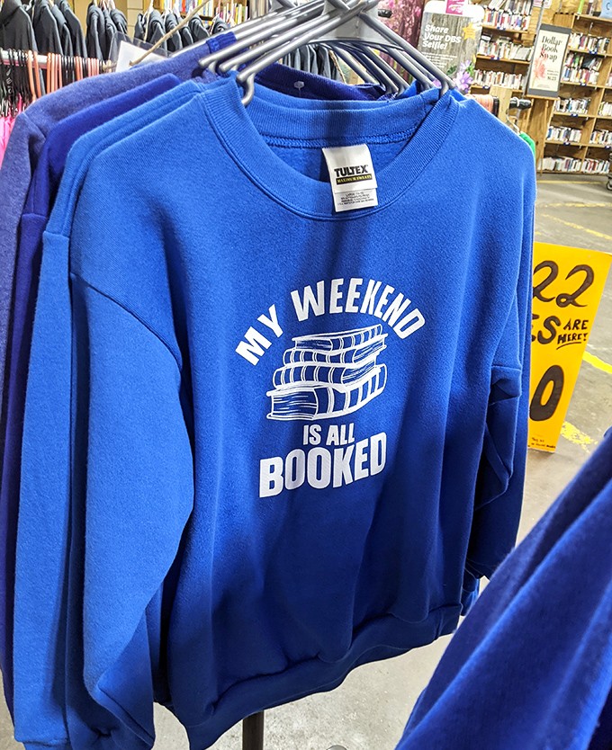 "My Weekend Is All Booked"&mdash;the official uniform of bibliophiles everywhere. The perfect attire for curling up with your Dollar Book Swap treasures and ignoring all responsibilities.
