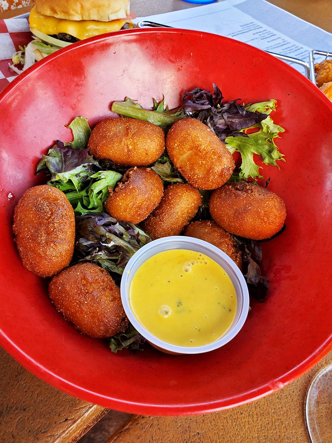 Mini corn dogs nestled on a bed of greens—nature's way of suggesting balance. That honey mustard dip is calling my name.