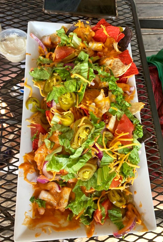 Nachos that refuse to be a mere appetizer. This colorful mountain of deliciousness demands respect—and extra napkins.