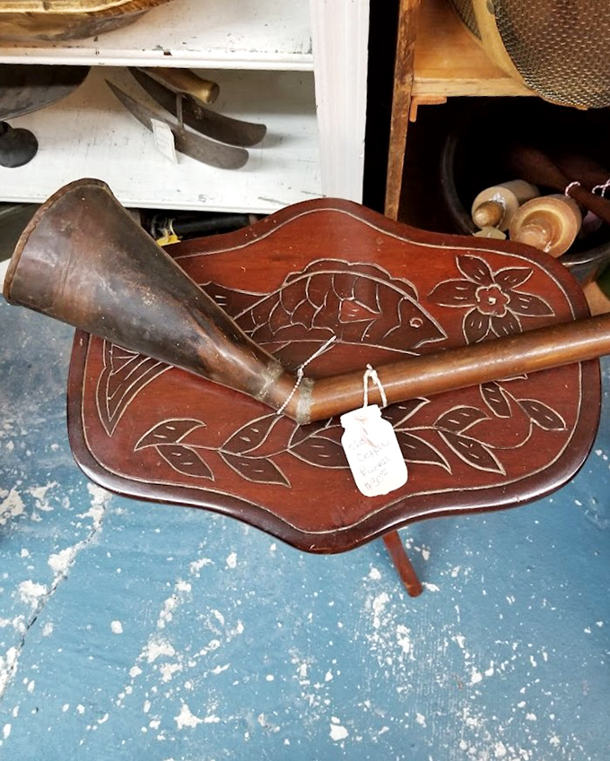 This carved wooden plaque and antique horn speak to a time when communication required more than just tapping a screen.