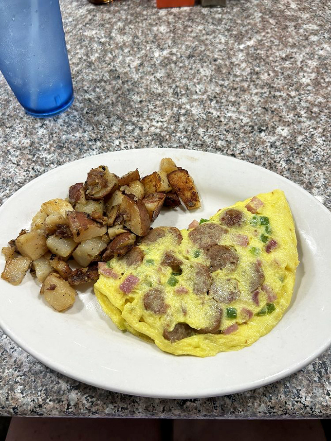 An omelet should be a canvas for creativity, and this one paints a delicious picture with ham, peppers, and perfectly crisped home fries.