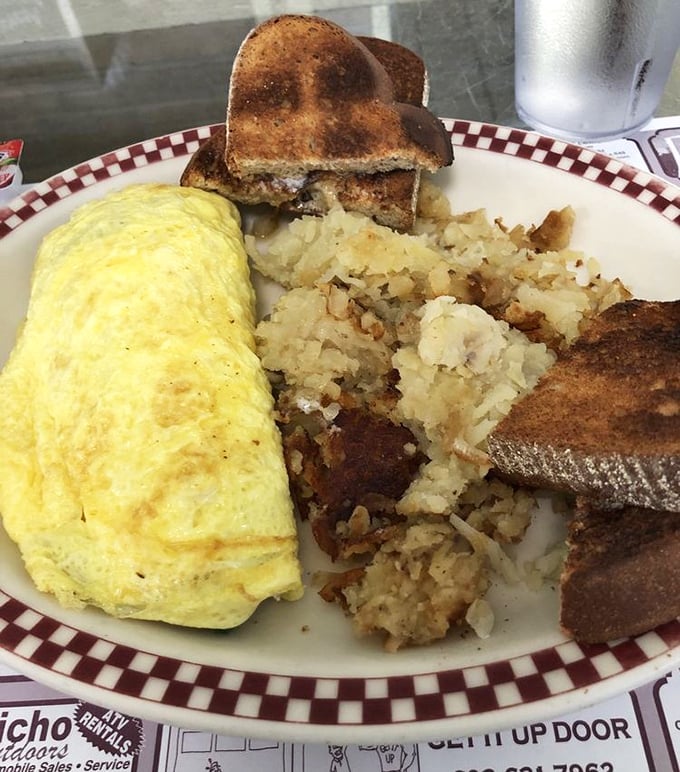 An omelet so fluffy it practically needs its own zip code, with home fries that have achieved that mythical crisp-yet-tender balance.