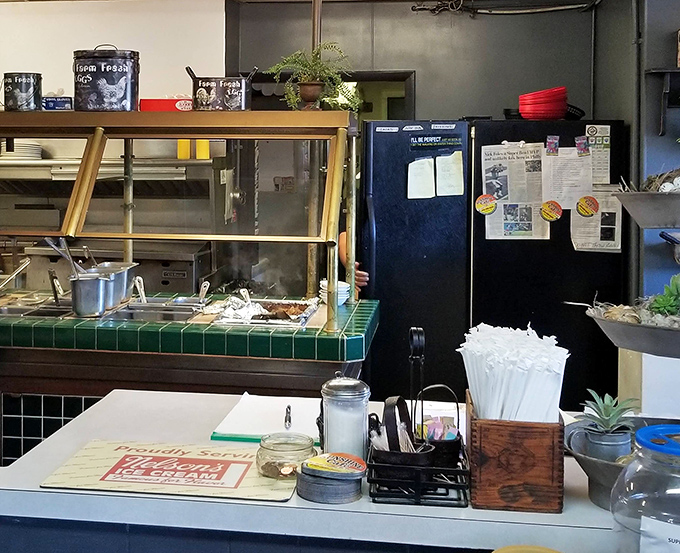The service counter reveals the organized chaos of a well-run diner kitchen &ndash; where breakfast magic happens without revealing all its secrets.