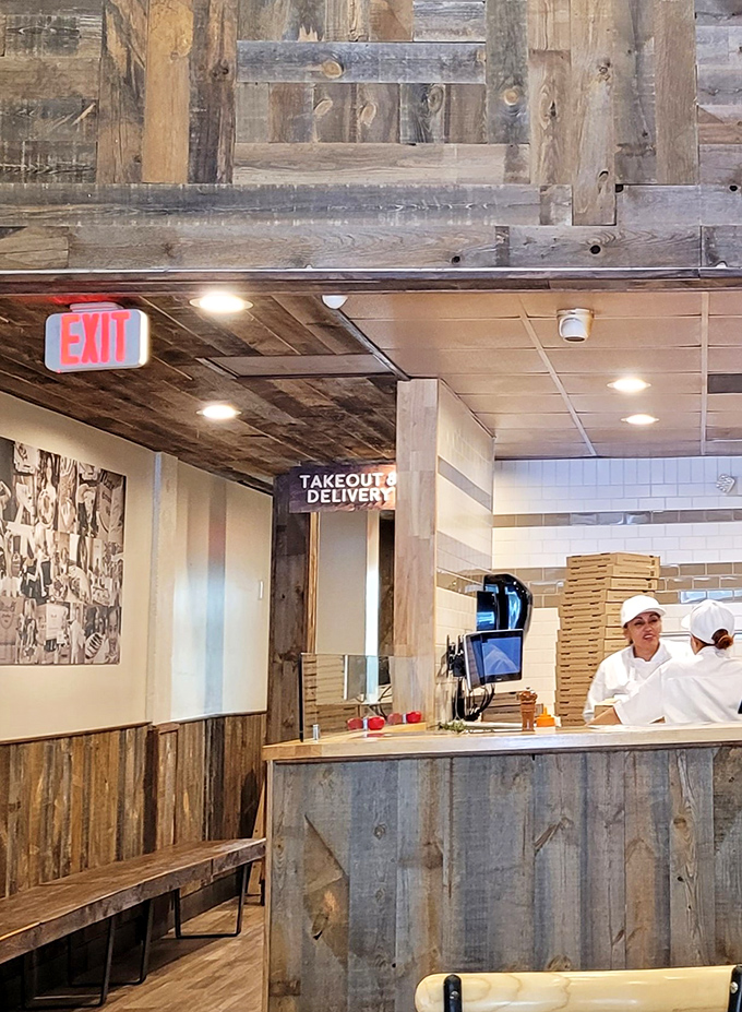 The takeout counter feels like a portal to happiness, where pizza dreams come boxed and ready for your Netflix marathon.