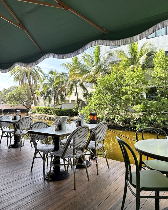 Dining under those fringed green umbrellas with palm trees swaying nearby&mdash;it's the Franco-Florida mash-up you never knew you needed.