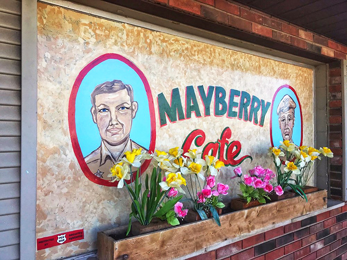 Spring flowers frame the iconic Mayberry Cafe sign, adding a touch of color to this shrine of nostalgic Americana and comfort cooking.