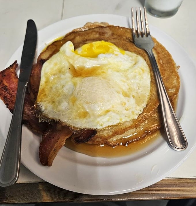 A pancake topped with a perfectly fried egg and bacon&mdash;breakfast doesn't need to be complicated to be extraordinary. This is morning joy on a plate.