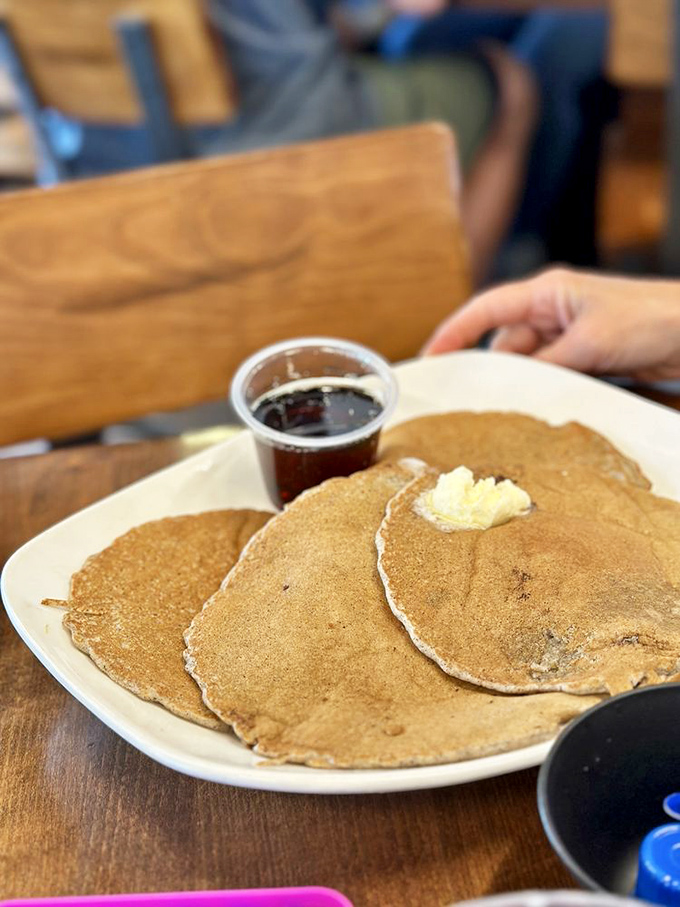 These aren't just pancakes; they're golden discs of morning happiness waiting to soak up butter and syrup like edible sunshine.