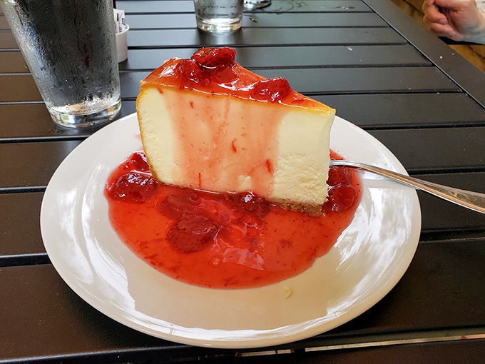 Panna cotta swimming in strawberry sauce&mdash;the kind of dessert that makes you seriously consider licking the plate when nobody's looking.