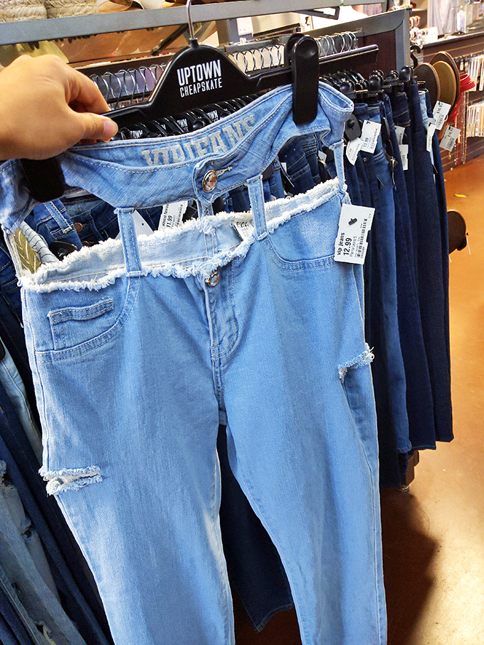 Denim dreams hanging in perfect formation. The branded hangers add that boutique touch to the thrift store experience.