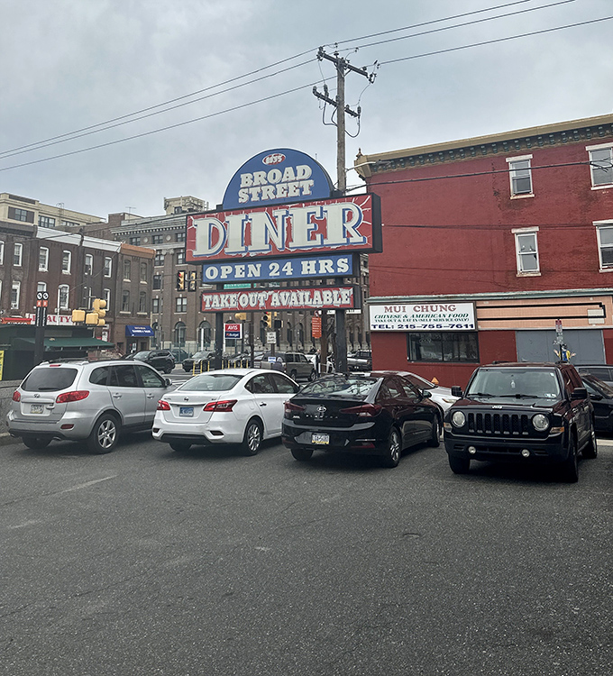 The neon sign glows like a lighthouse for hungry travelers, promising "OPEN 24 HRS" when most respectable establishments have long since closed their doors.
