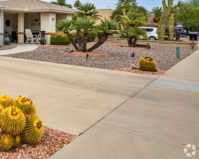 Cactus guardians stand watch over these stylish homes. Desert landscaping proves you don't need grass to have curb appeal that stops traffic.
