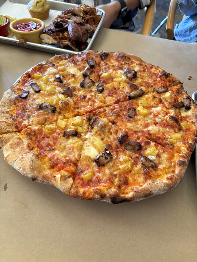 Wood-fired pizza topped with smoky brisket and pineapple&mdash;a combination that somehow makes perfect sense when you're actually eating it.