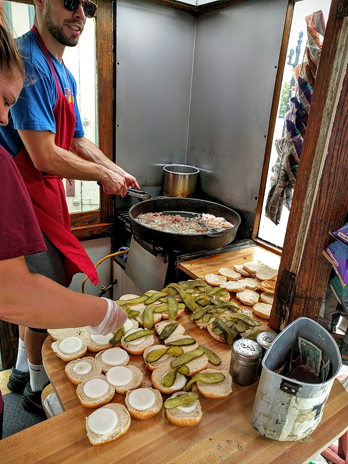 Hands in motion, creating edible history. The assembly line hasn't changed much since your grandparents might have stood in this very line.