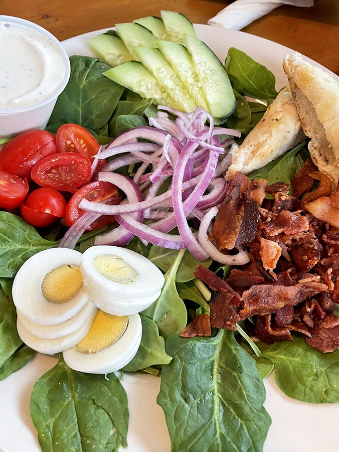 Fresh salad perfection that proves healthy eating doesn't have to taste like punishment or cardboard disappointment.