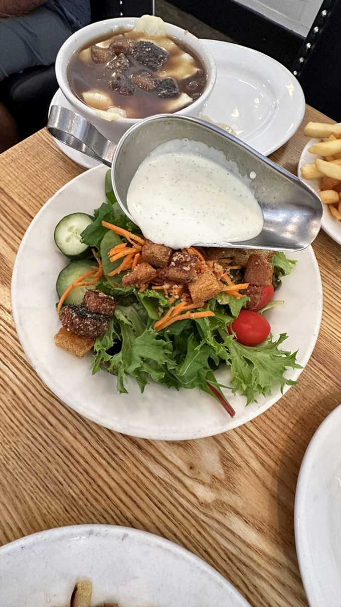 A salad that doesn't apologize for being healthy, dressed in a creamy potion that makes vegetables feel like they're attending a fancy gala.