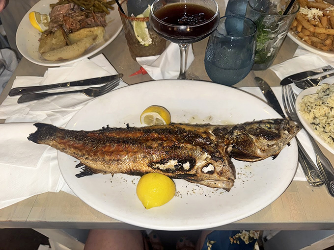 A whole grilled fish stares back at you, its crispy skin and tender flesh offering a direct line to Greek coastal dining&mdash;minus the Aegean view and stray cats.