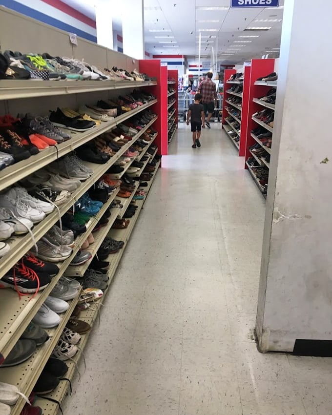 The shoe aisle stretches toward infinity. Somewhere in this footwear forest is a pair with your name on them.