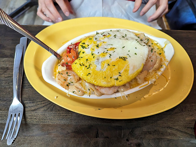 Shrimp and grits with a sunny-side egg crown&mdash;Southern comfort food that's dressed for success and ready to impress.