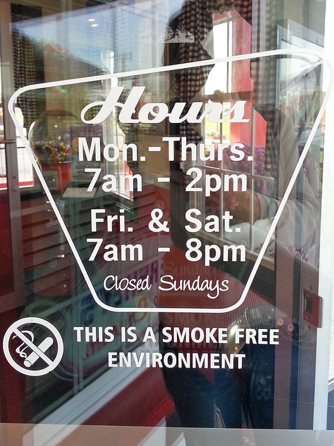 Hours posted with vintage flair. Notice they're closed Sundays&mdash;even time travelers need a day off.