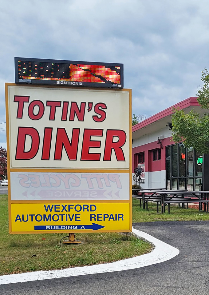 The roadside sign stands proud, a North Star for hungry travelers. Even automotive repair customers next door know where to fuel up first.