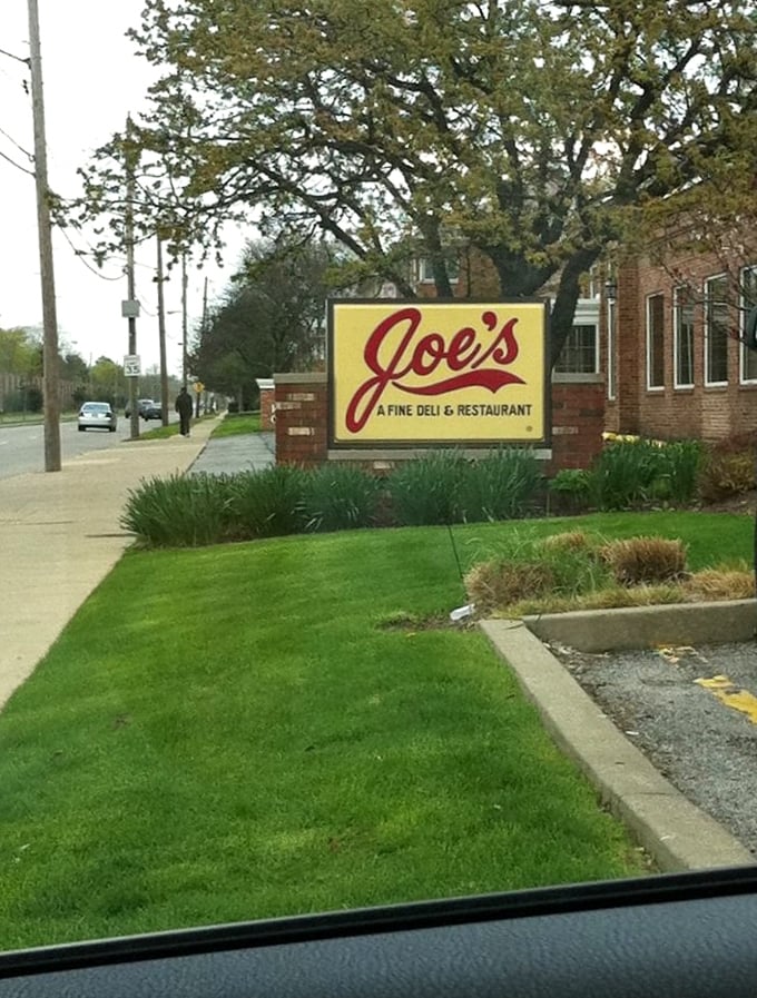 The roadside sign stands as a beacon of hope for the hungry traveler, promising salvation in sandwich form just ahead.