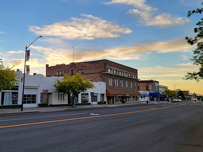 Golden hour transforms Main Street into a painter's dream, where historic buildings glow warmly against the mountain backdrop.