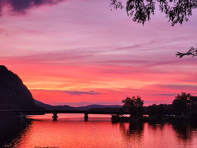 Nature's own light show outperforms any fireworks display as sunset paints the Susquehanna in impossible shades of pink and orange.