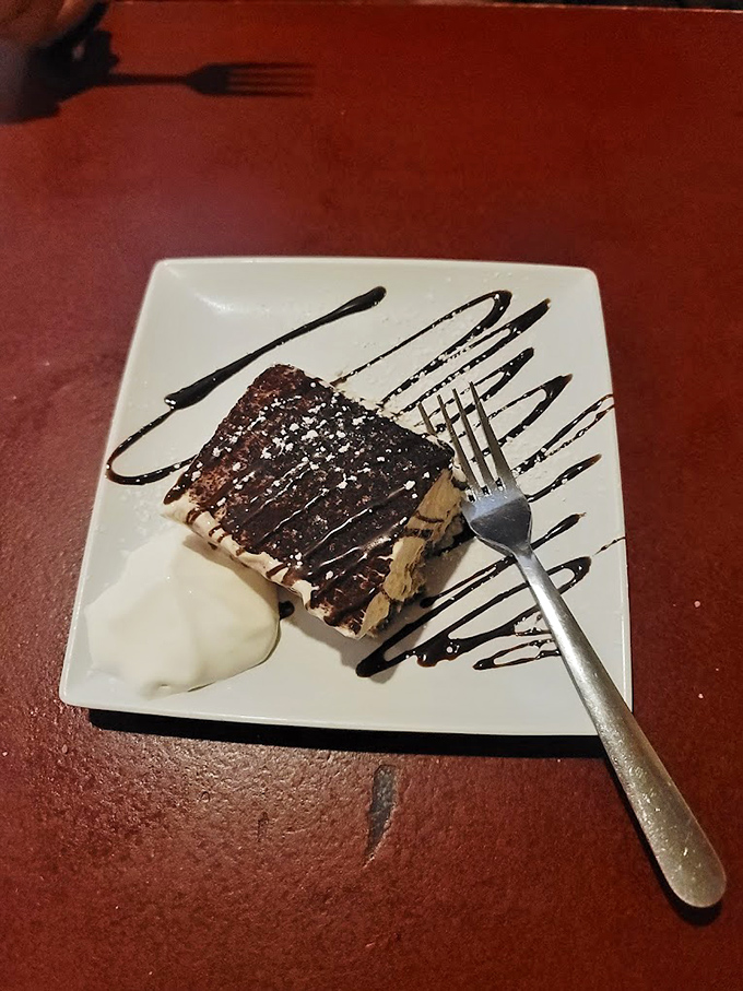 This tiramisu isn't just dessert&mdash;it's a caffeine-infused cloud of mascarpone heaven, artfully presented with chocolate drizzle calligraphy.