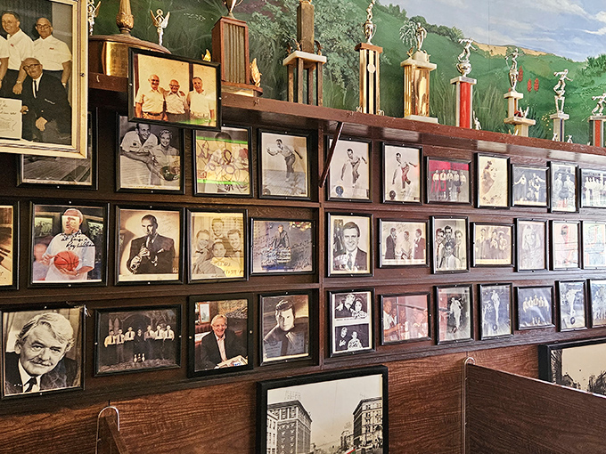 The wall of memories tells Luigi's story through photographs and trophies, a visual testament to decades of serving as Akron's unofficial living room.