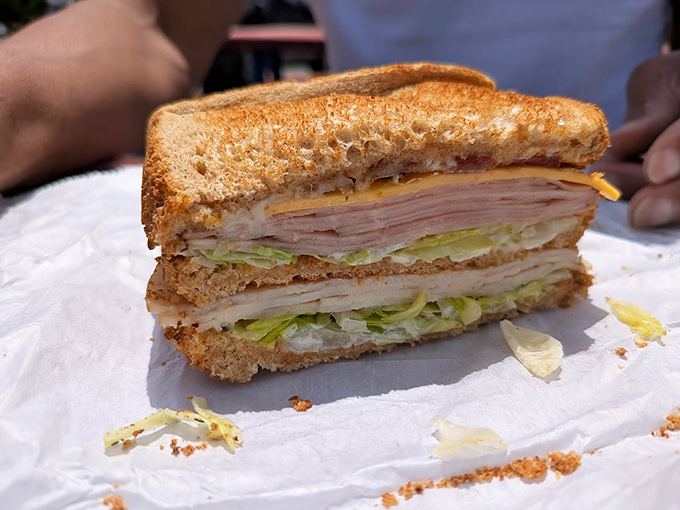 The classic club sandwich, cut into perfect triangles, proves that some culinary traditions are worth preserving exactly as they've always been.