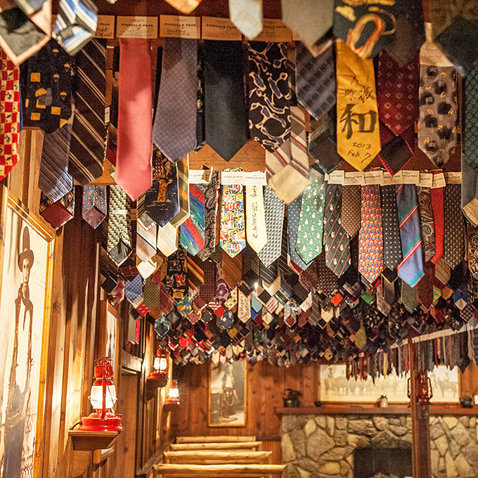 The necktie collection overhead isn't just decoration&mdash;it's a warning to all who enter wearing business attire. Hundreds of former ties stand witness.