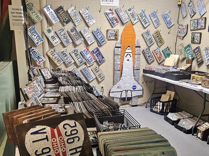 A wall of automotive history where every license plate represents road trips, family vacations, and the great American highway.