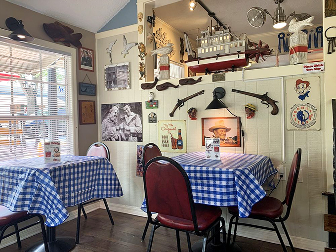 Blue checkered tablecloths and walls adorned with vintage photos and nautical treasures create a dining room that feels like a maritime time capsule.