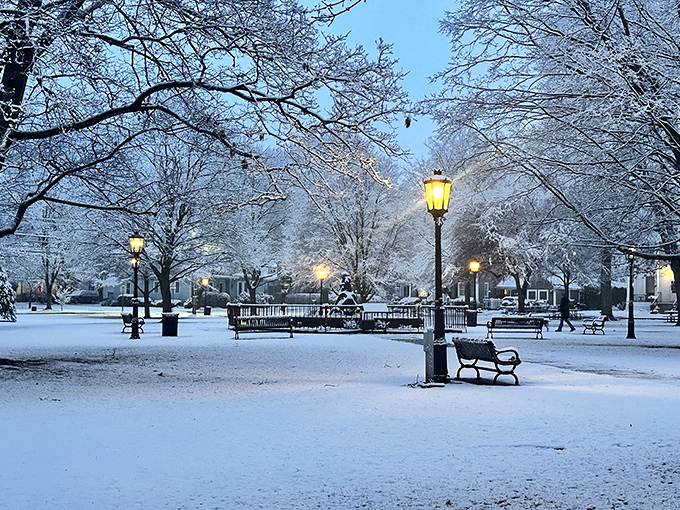 Winter transforms The Green into a snow globe come to life, with gas lamps glowing like beacons in a white wonderland.