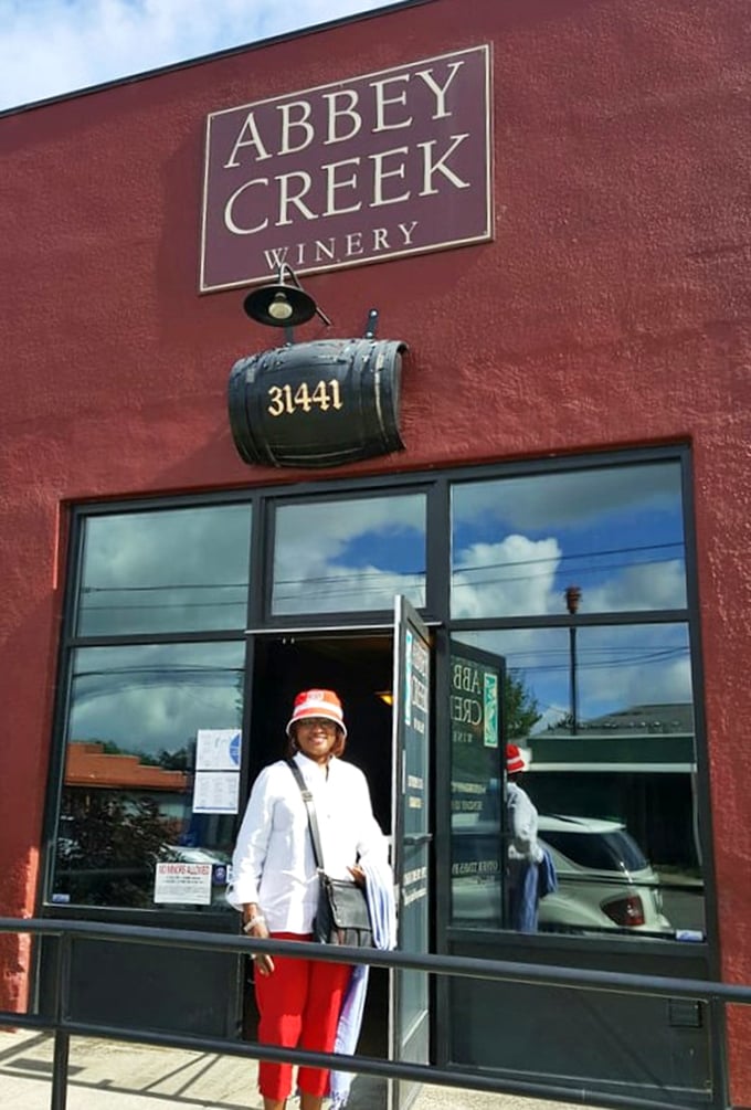 Classic red barn storefront welcomes visitors with small-town charm where great wine meets friendly faces.