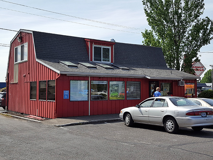 Donut World's distinctive red barn-like building stands as a beacon of breakfast joy in Gresham.