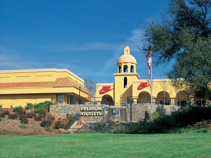 Folsom Premium Outlets' yellow Nike sign shines like retail sunshine. Athletic gear at prices that won't make you break a sweat!
